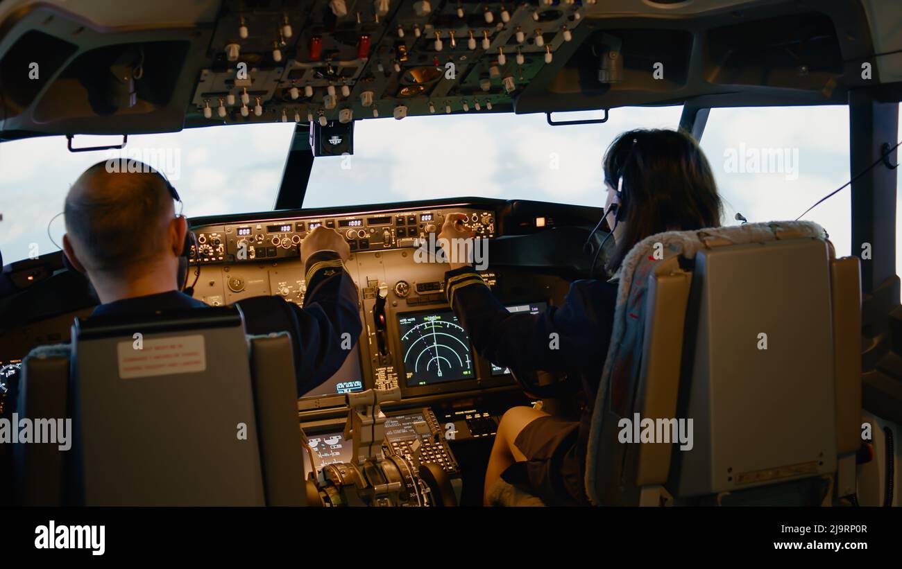 Team of aviators throttling power engine and fixing altitude level ...