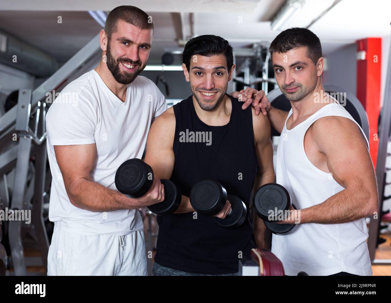 Three male friends in gym Stock Photo - Alamy