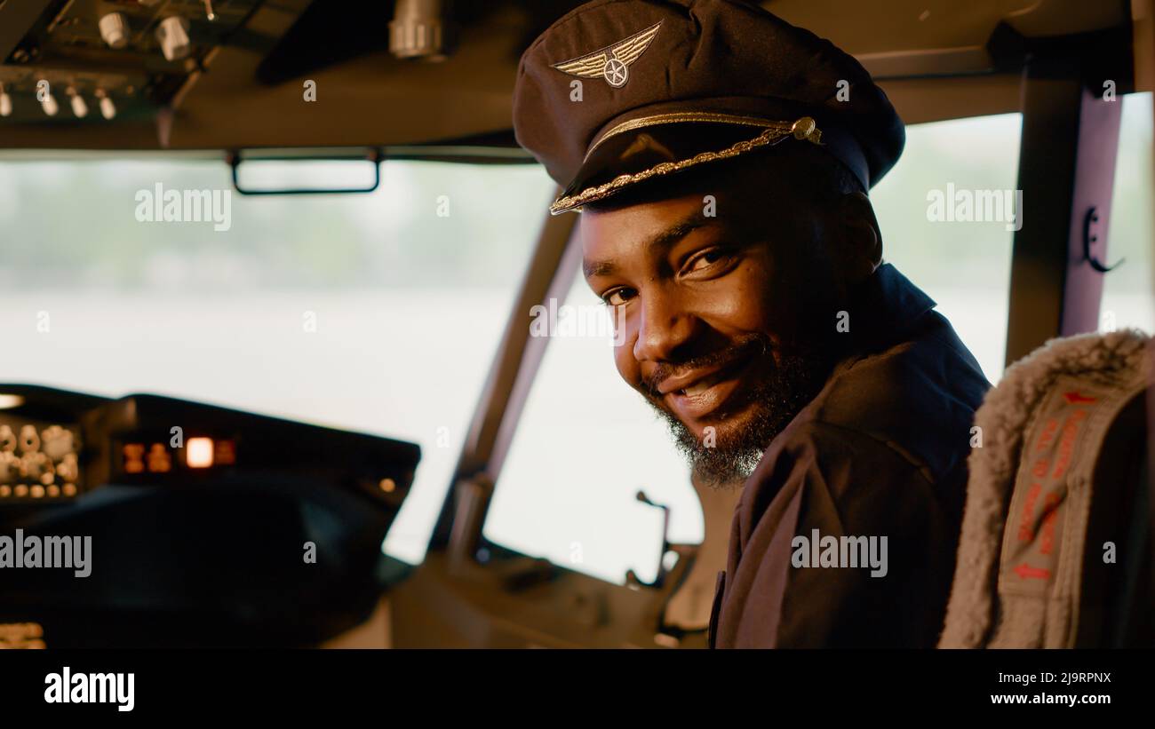 Portrait of male captain sitting in airplane cockpit to start engine ...