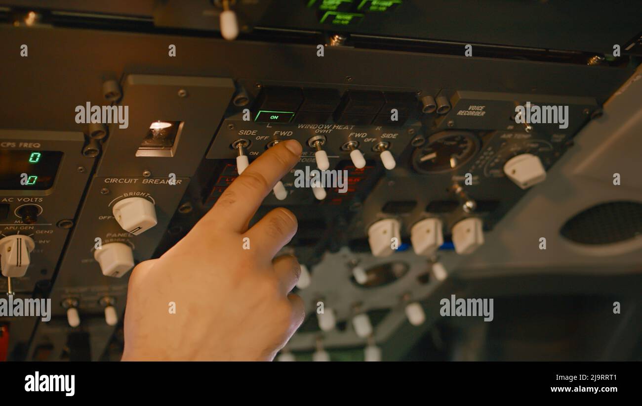 Airplane captain starting aircraft engine power buttons on control ...