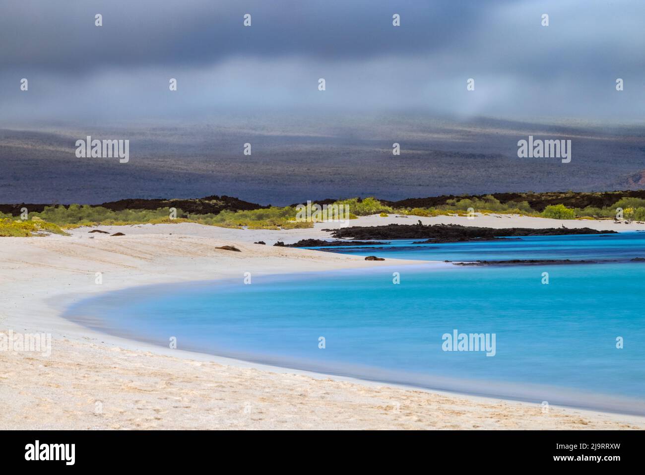 Lava rocks along tranquil shoreline of San Cristobal Island, Galapagos ...
