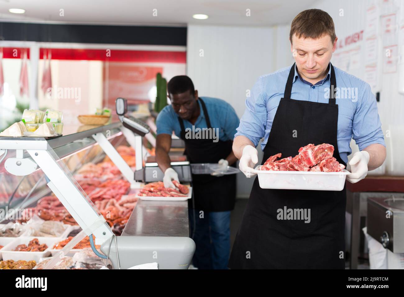 Butchers preparing meat products for sale Stock Photo - Alamy