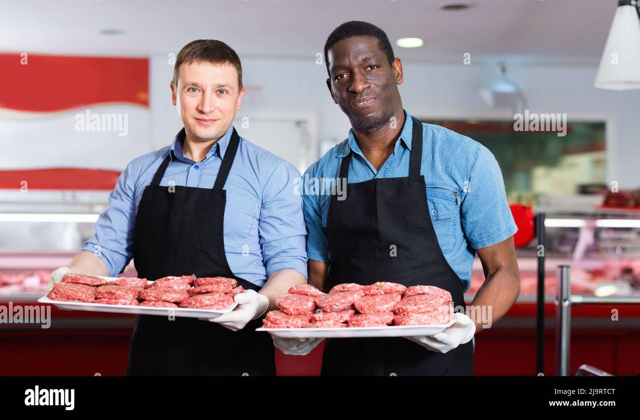 Successful sellers of butcher store offering fresh raw meat steak ...