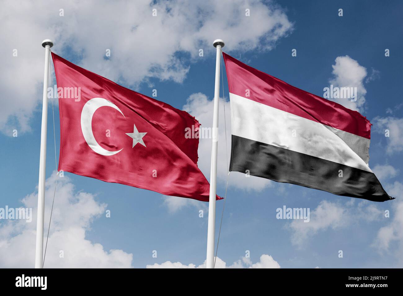 Turkey and Yemen two flags on flagpoles and blue cloudy sky background ...