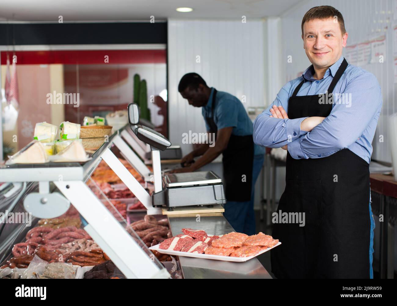Confident owner of butcher shop Stock Photo - Alamy