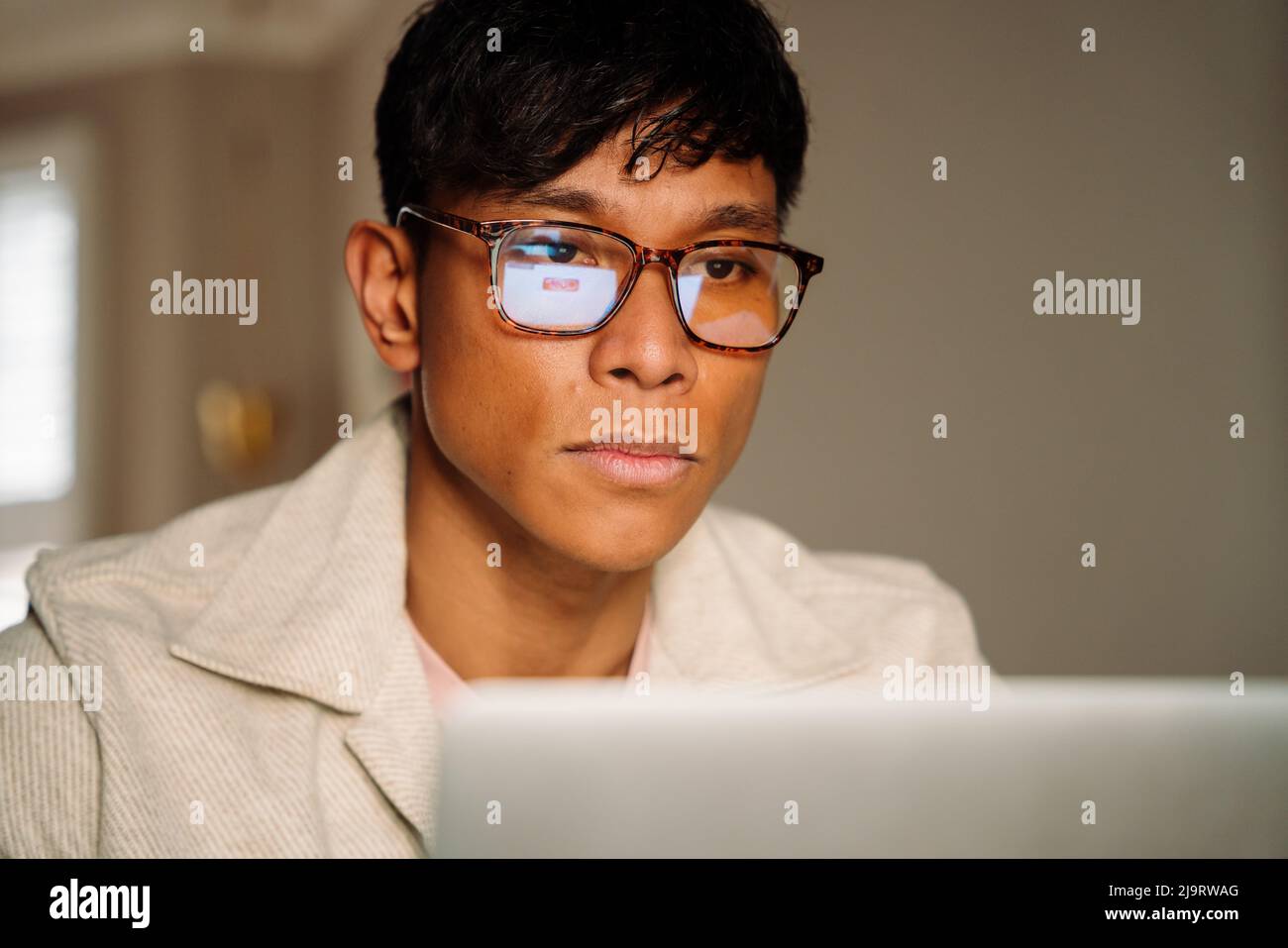 Asian Male working online with glasses Stock Photo - Alamy