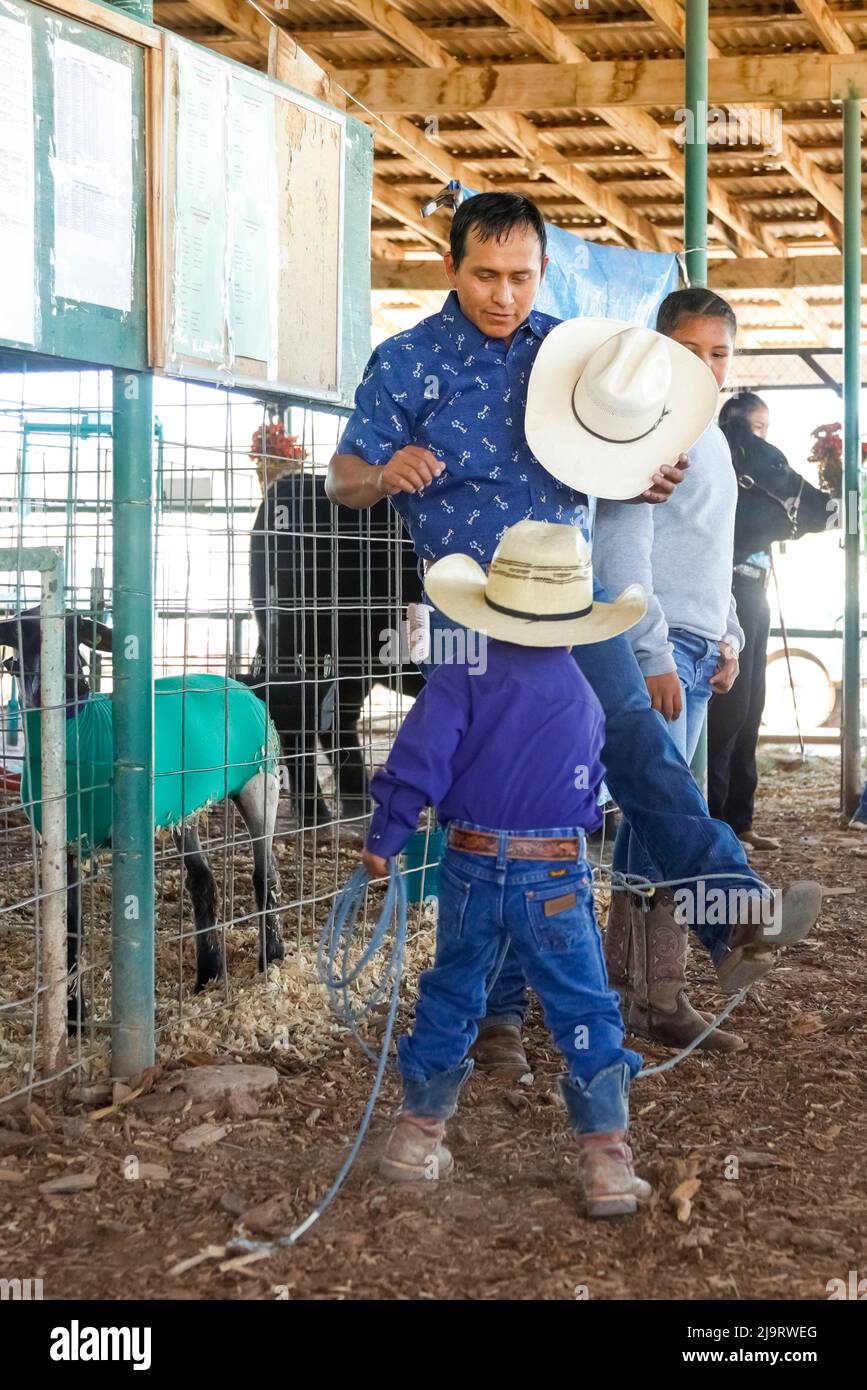 Window Rock, Arizona, USA. Navajo Nation Fair. Adult and boy playing in ...