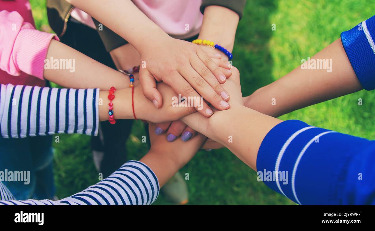 People put their hands together. Selective focus Stock Photo - Alamy
