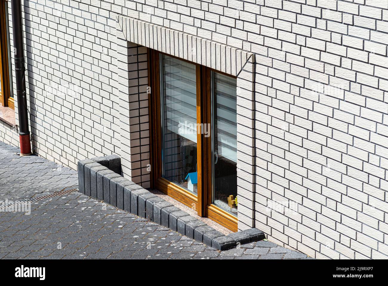 The church has a classic facade of white brick and a conical roof ...