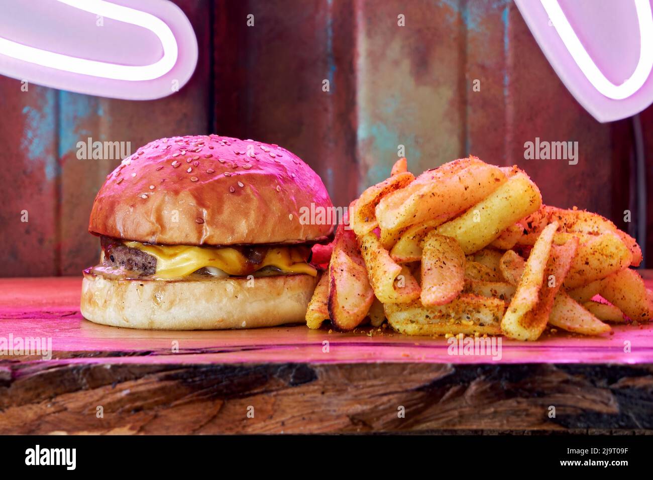 One hamburger, burger, or cheeseburger on wooden plate with French ...