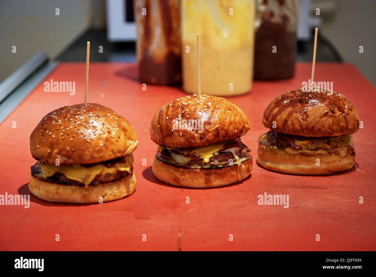Burgers, hamburgers or cheeseburgers on the restaurant kitchen counter ...