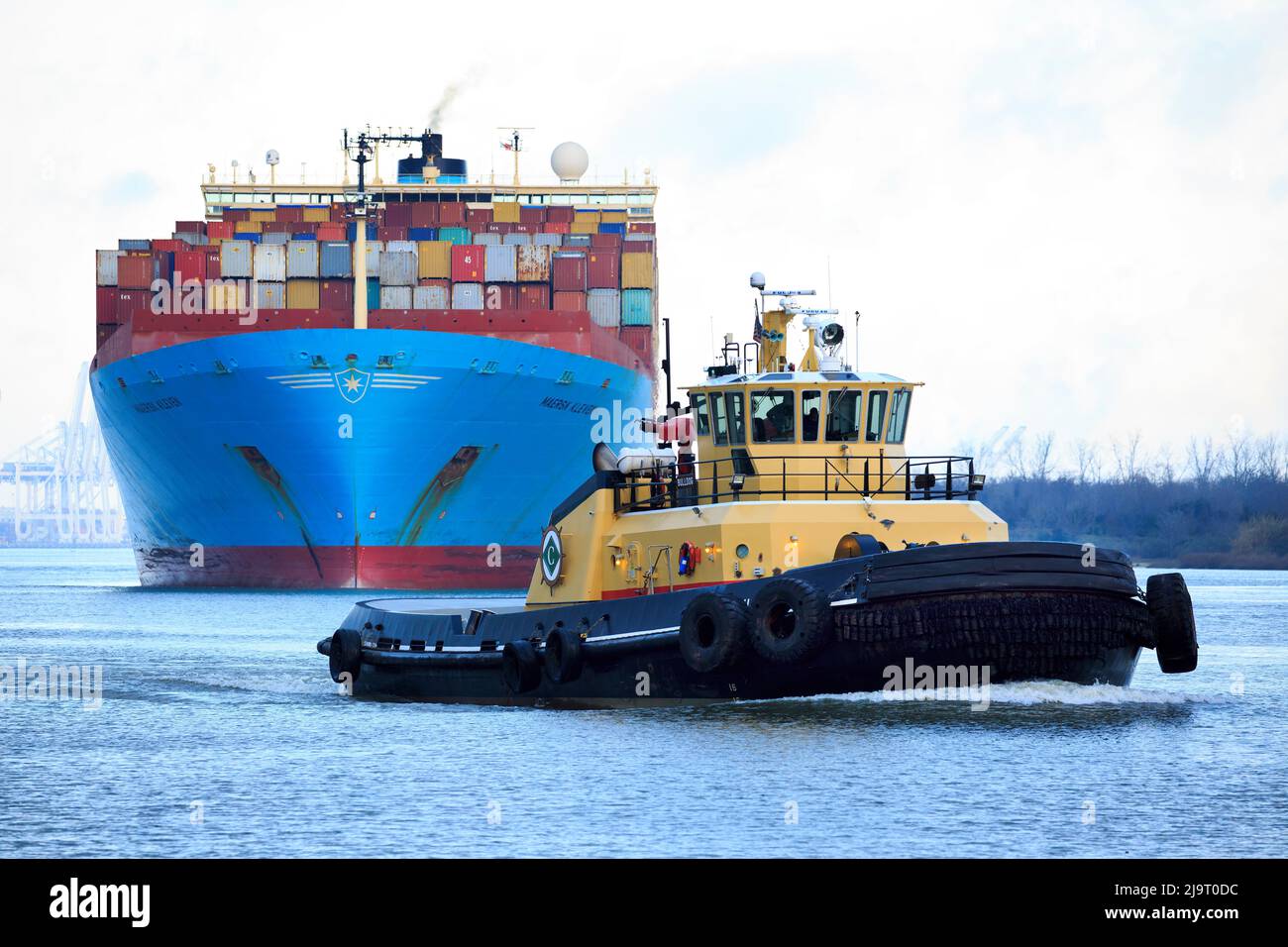 USA, Georgia, Savannah. Container ship escorted out of Savannah Harbor ...