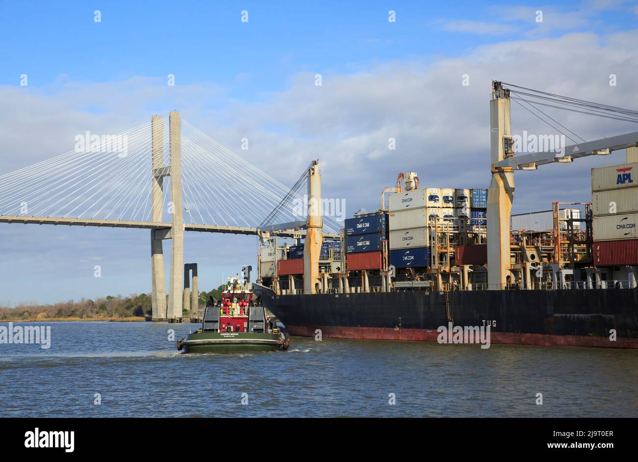 USA, Georgia, Savannah. Container ship escorted into Savannah Harbor ...