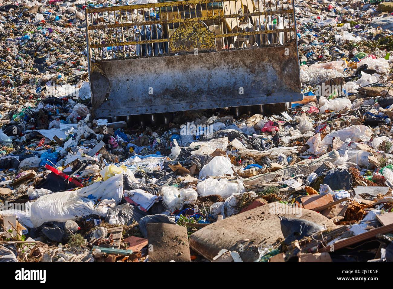 Heavy machinery shredding garbage in an open air landfill. Waste Stock ...
