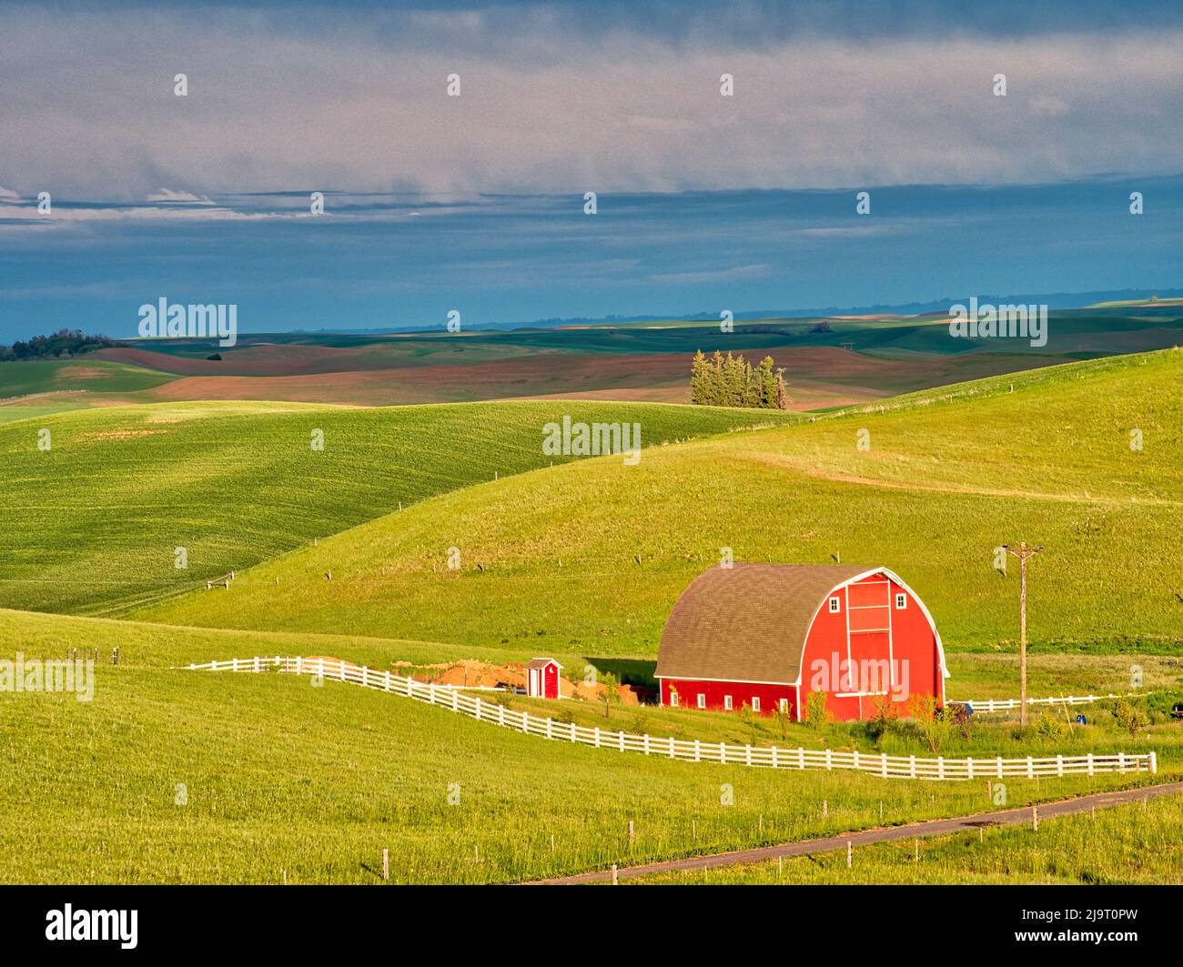 USA, Idaho, Palouse. Red barn with dark clouds and warm light Stock ...