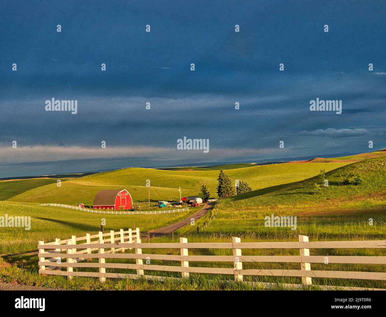 USA, Idaho, Palouse. Red barn with dark clouds and warm light Stock ...