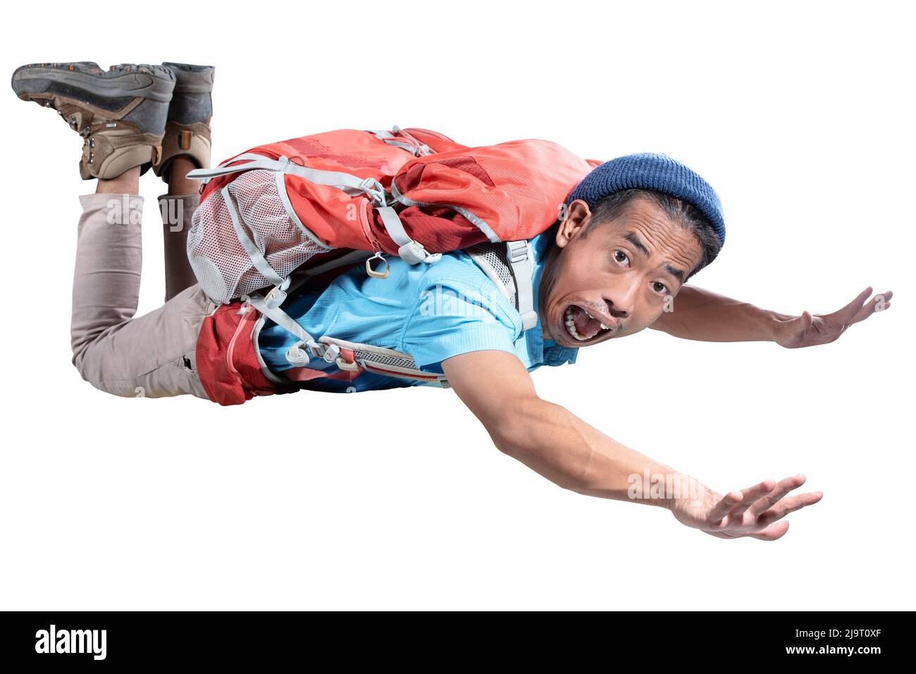 Asian man with a beanie hat and backpack falling down isolated over ...