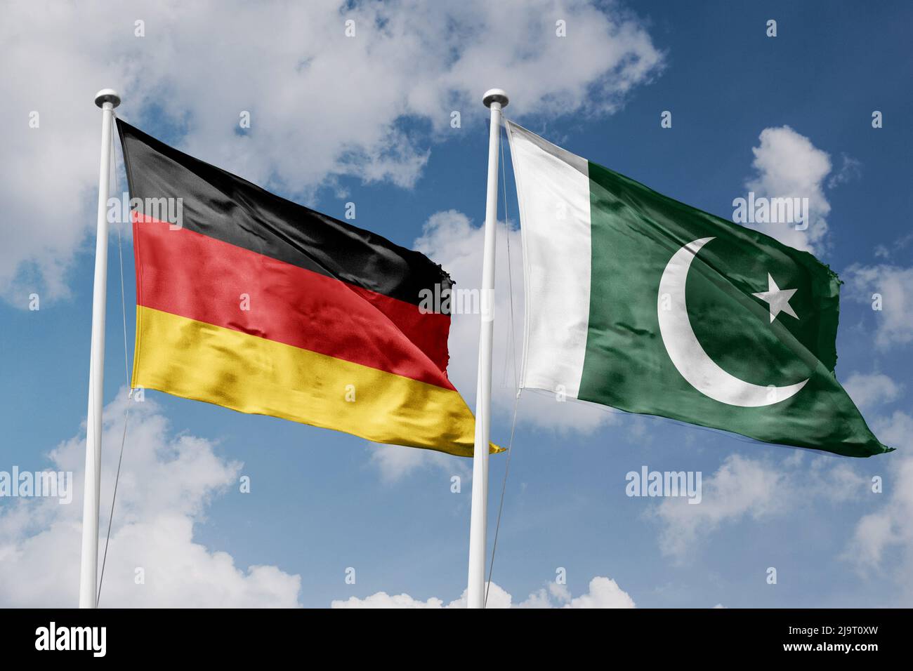 Germany and Pakistan two flags on flagpoles and blue cloudy sky ...