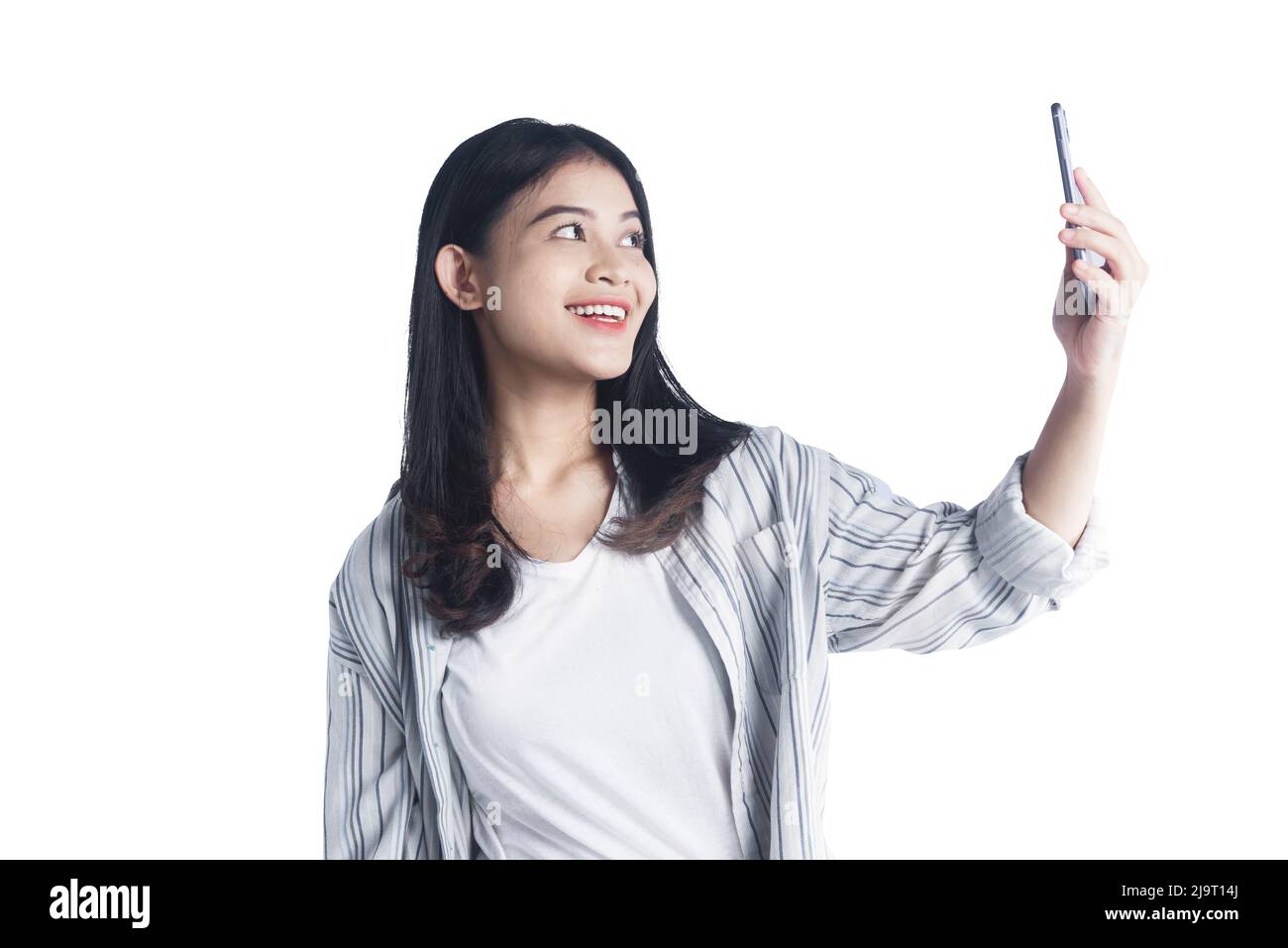 Asian woman taking a self-portrait with her phone isolated over white ...