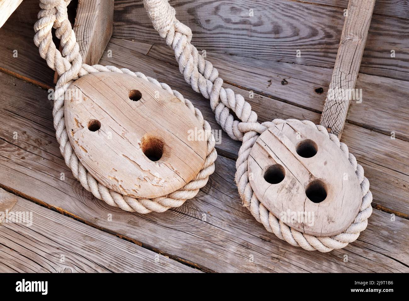 Ancient marine pulleys with rope on a wooden sailboat Stock Photo - Alamy