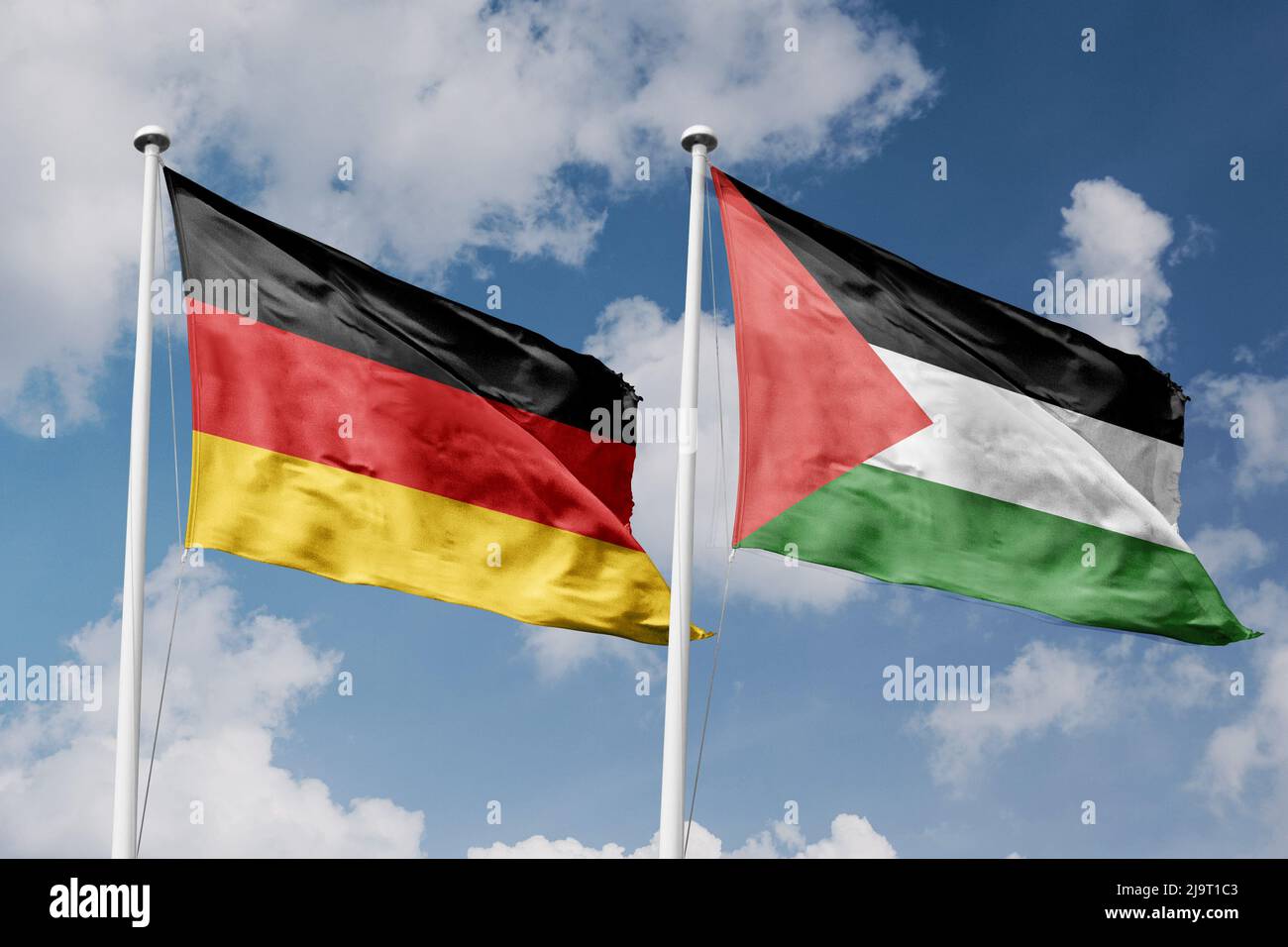 Germany and Palestine two flags on flagpoles and blue cloudy sky ...
