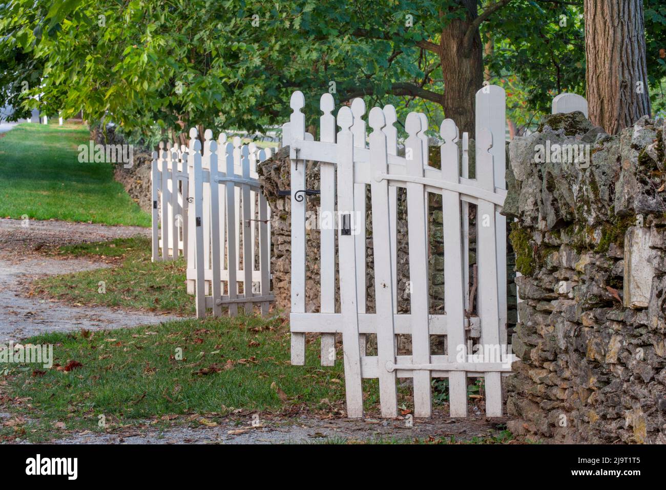 Gate and white wooden fence and rock wall, Shaker Village of Pleasant ...