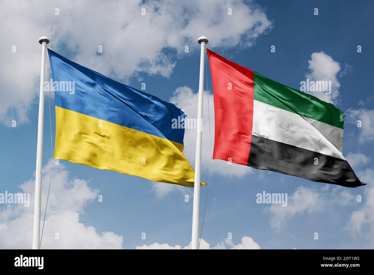 Ukraine and United Arab Emirates two flags on flagpoles and blue cloudy ...