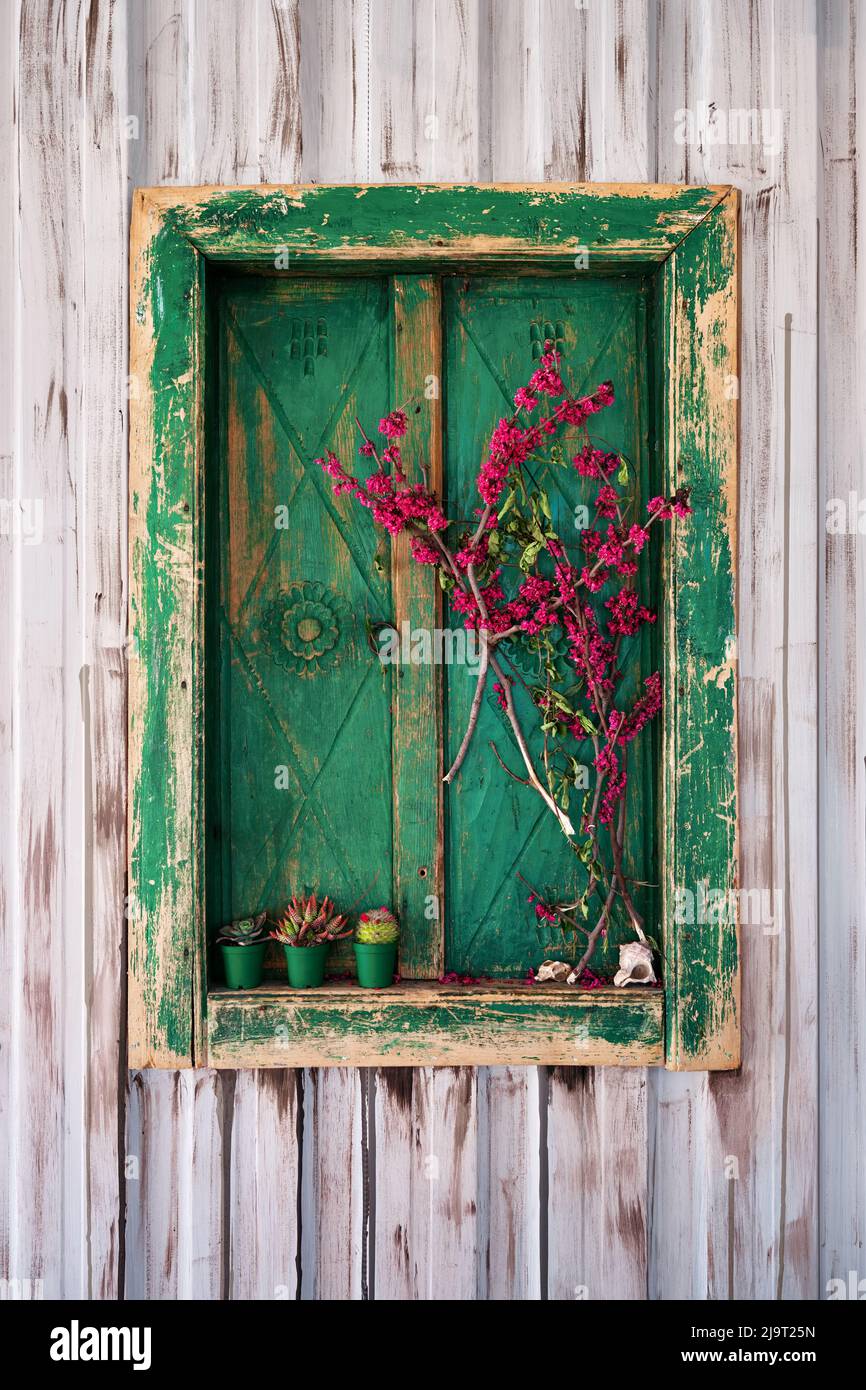 Green wooden antique window frame with shutters and decorated with ...
