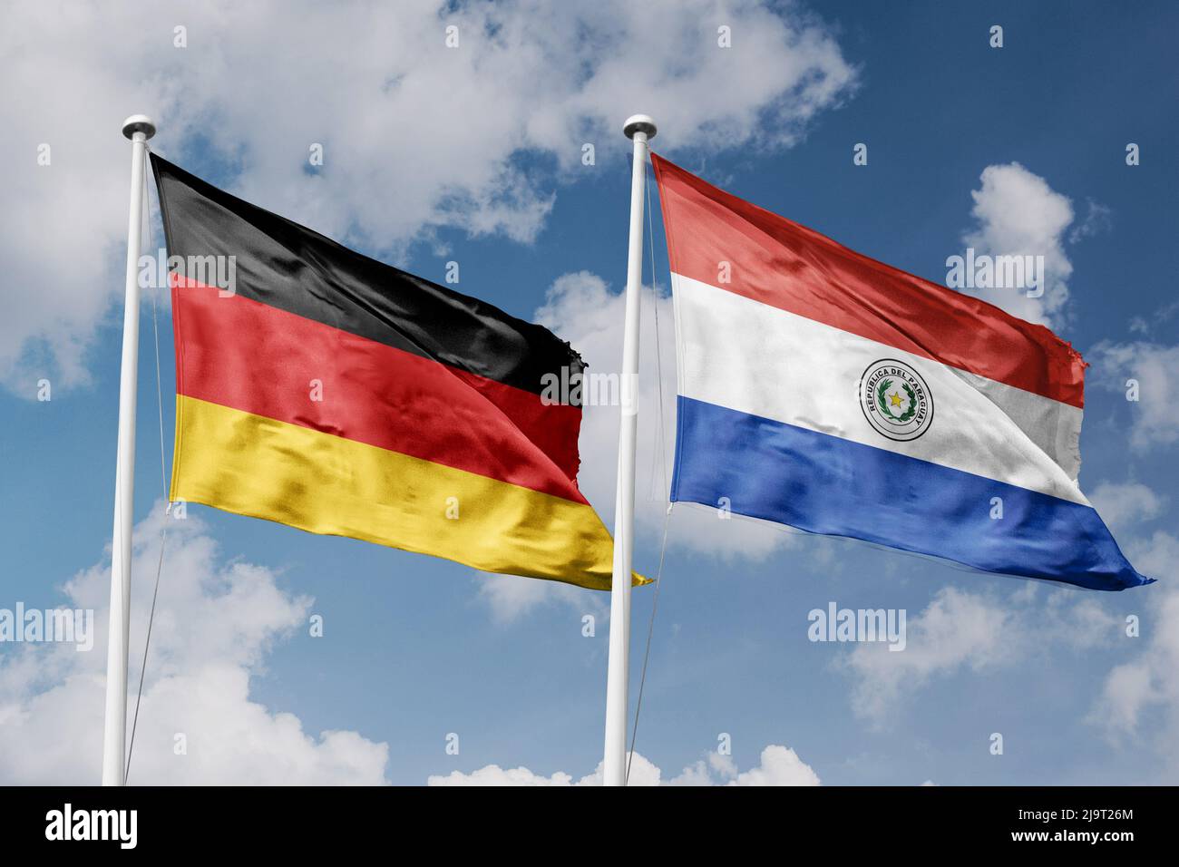 Germany and Paraguay two flags on flagpoles and blue cloudy sky ...