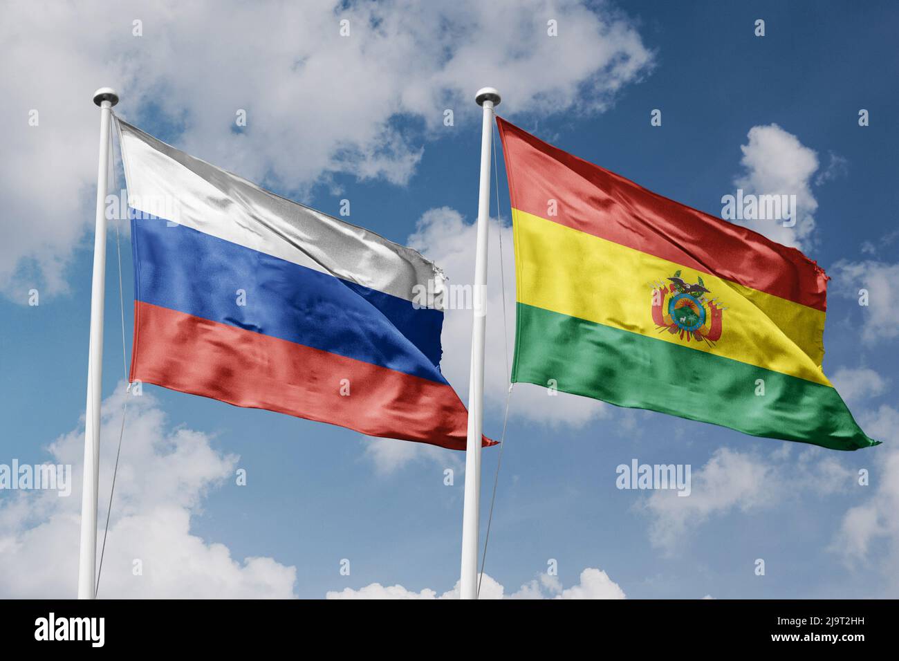 Russia and Bolivia two flags on flagpoles and blue cloudy sky ...
