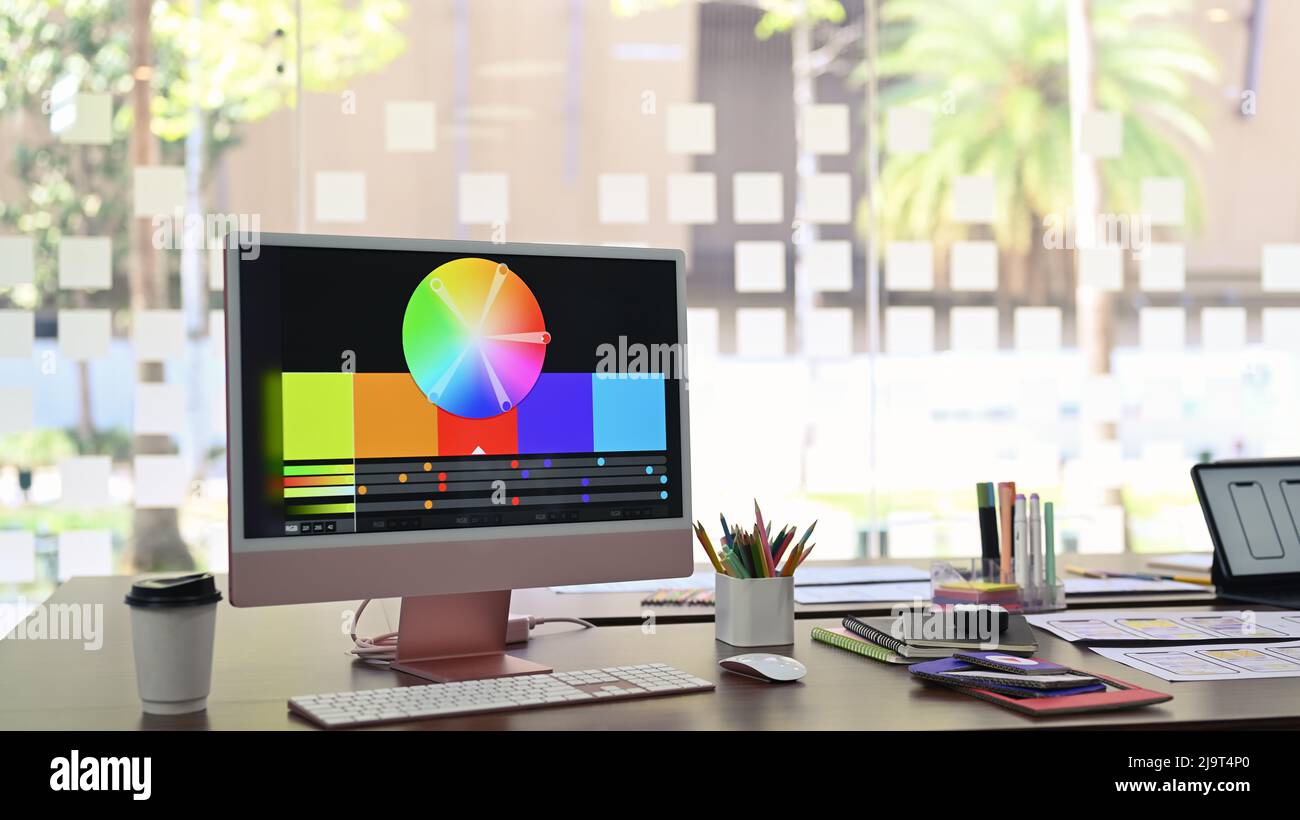 Design studio with computer, color swatches and wireframe sketches for ...