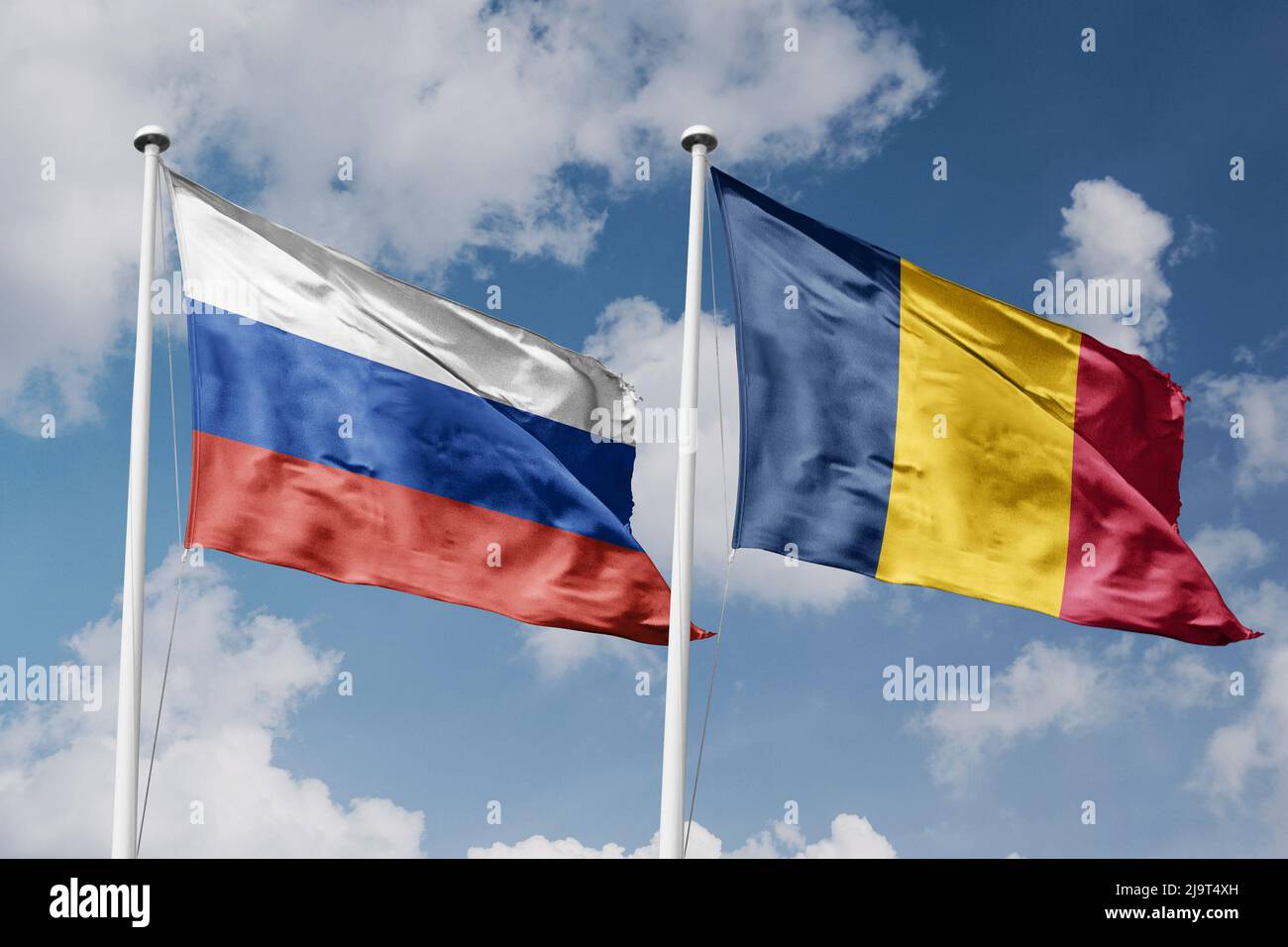 Russia and Chad two flags on flagpoles and blue cloudy sky background ...