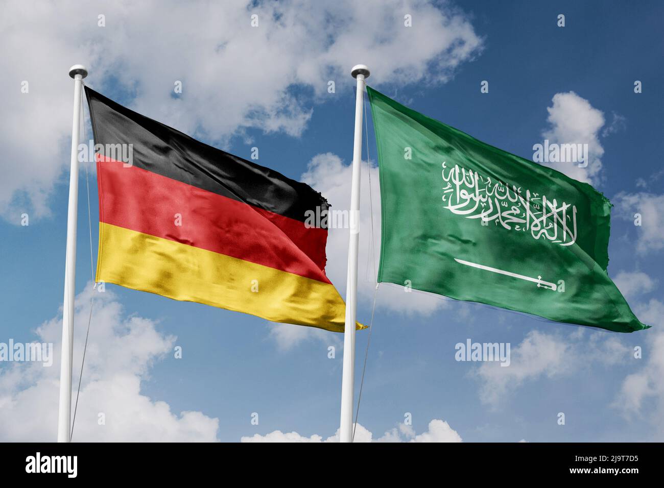 Germany and Saudi Arabia two flags on flagpoles and blue cloudy sky ...