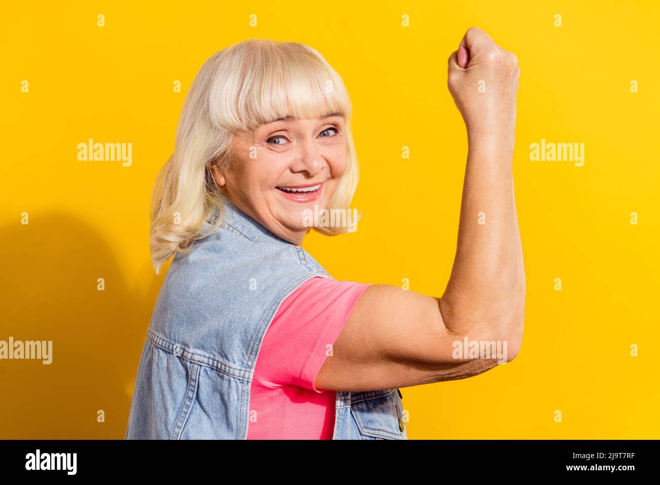 Photo of sweet strong lady pensioner dressed denim waistcoat showing ...