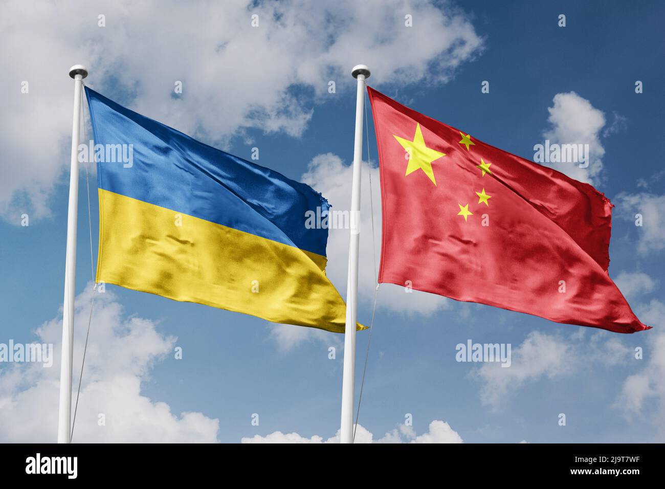 Ukraine and China two flags on flagpoles and blue cloudy sky background ...