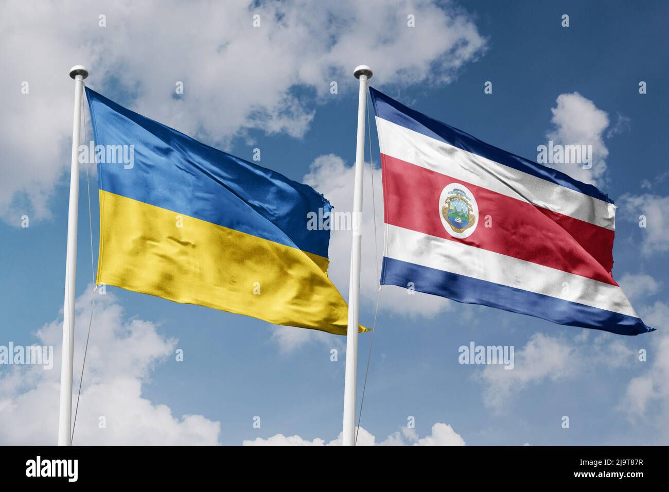 Ukraine and Costa Rica two flags on flagpoles and blue cloudy sky ...