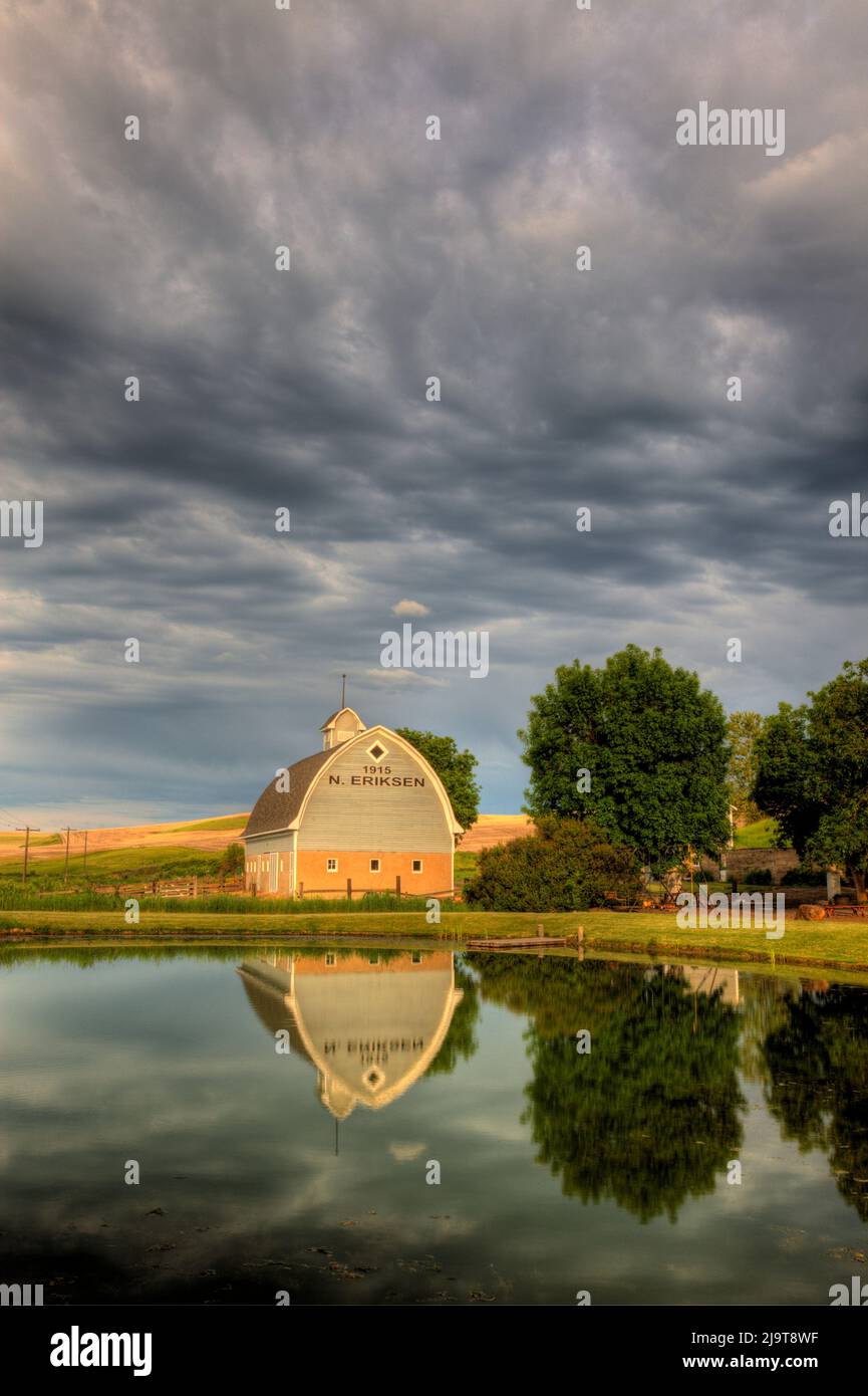 USA, Washington State, Palouse. Reflection of the Erickson barn in pond ...