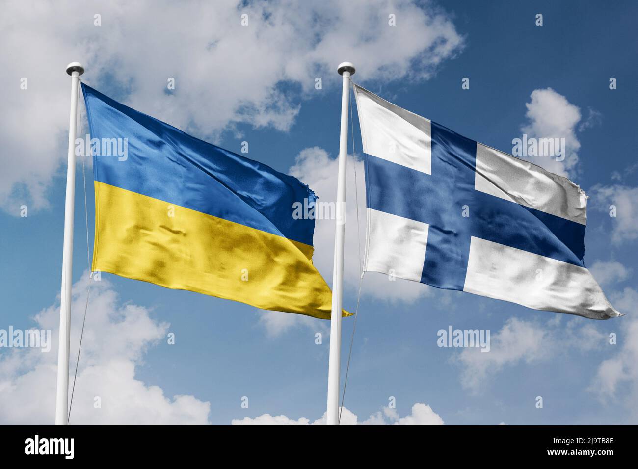 Ukraine and Finland two flags on flagpoles and blue cloudy sky ...
