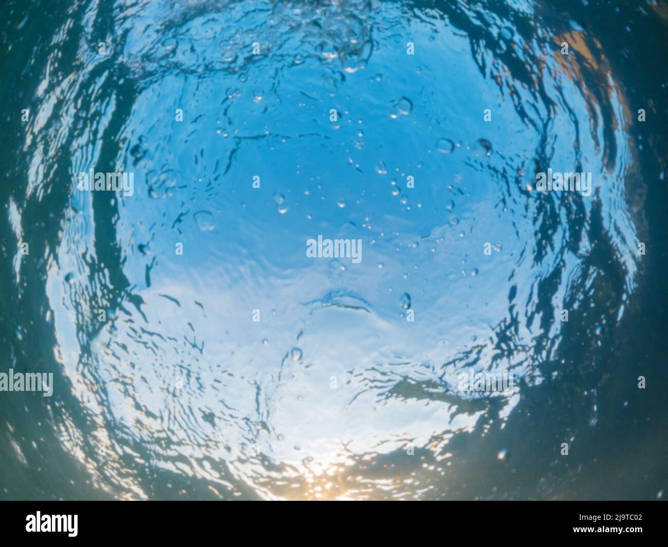 Through the sea rippled water you can see blue sky and sunlight ...