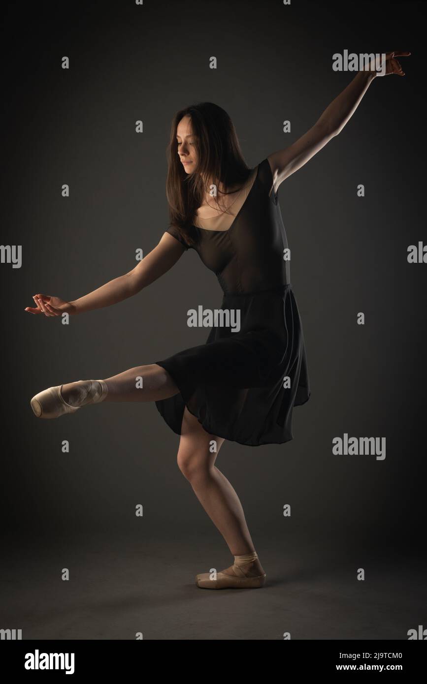 Elegant ballerina with pointe shoes is doing a perfect ballet pose in ...