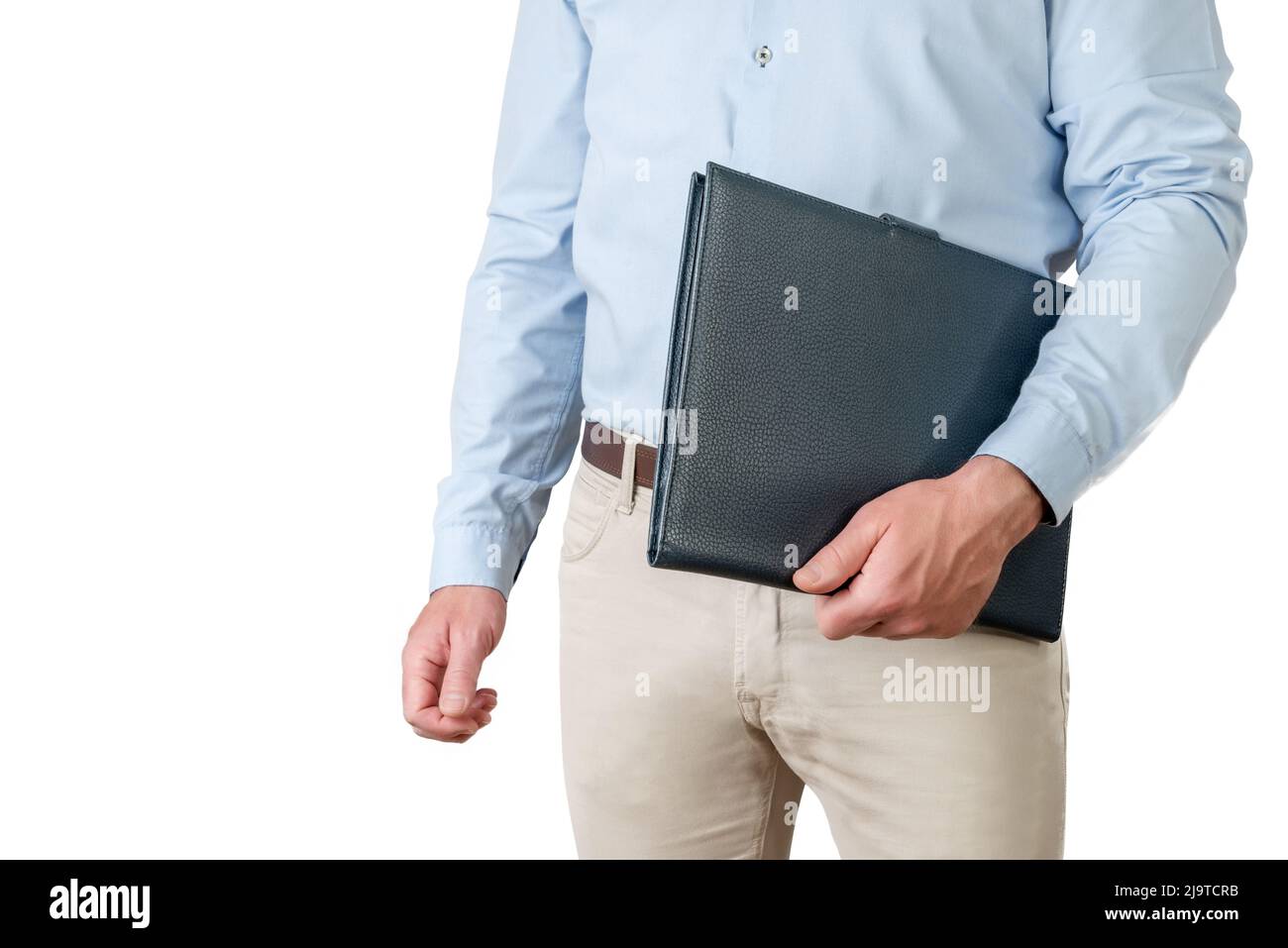 Man in light blue shirt and beige pants holding a folder under his arm ...