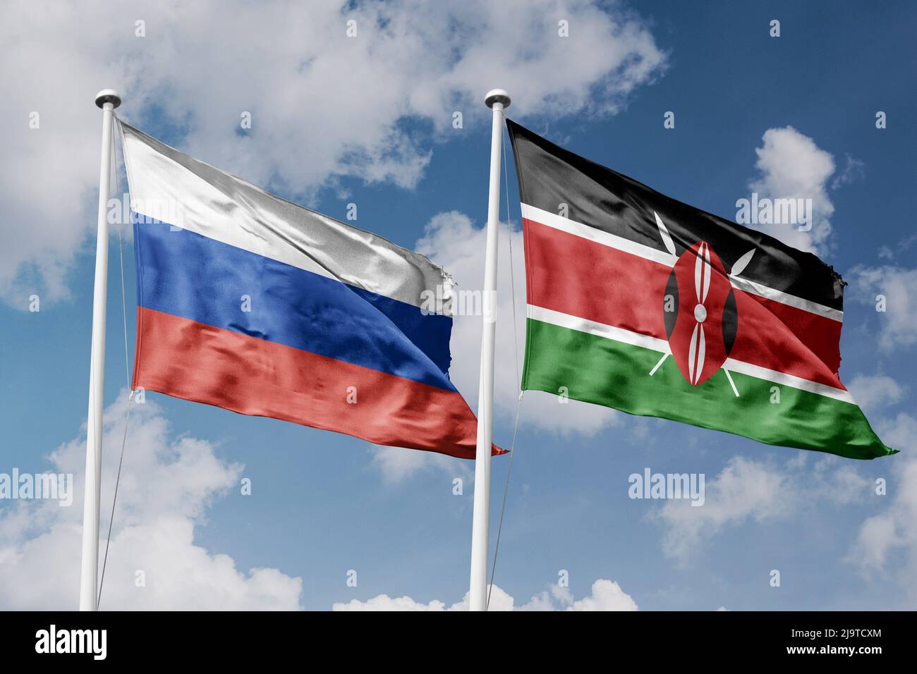 Russia and Kenya two flags on flagpoles and blue cloudy sky background ...