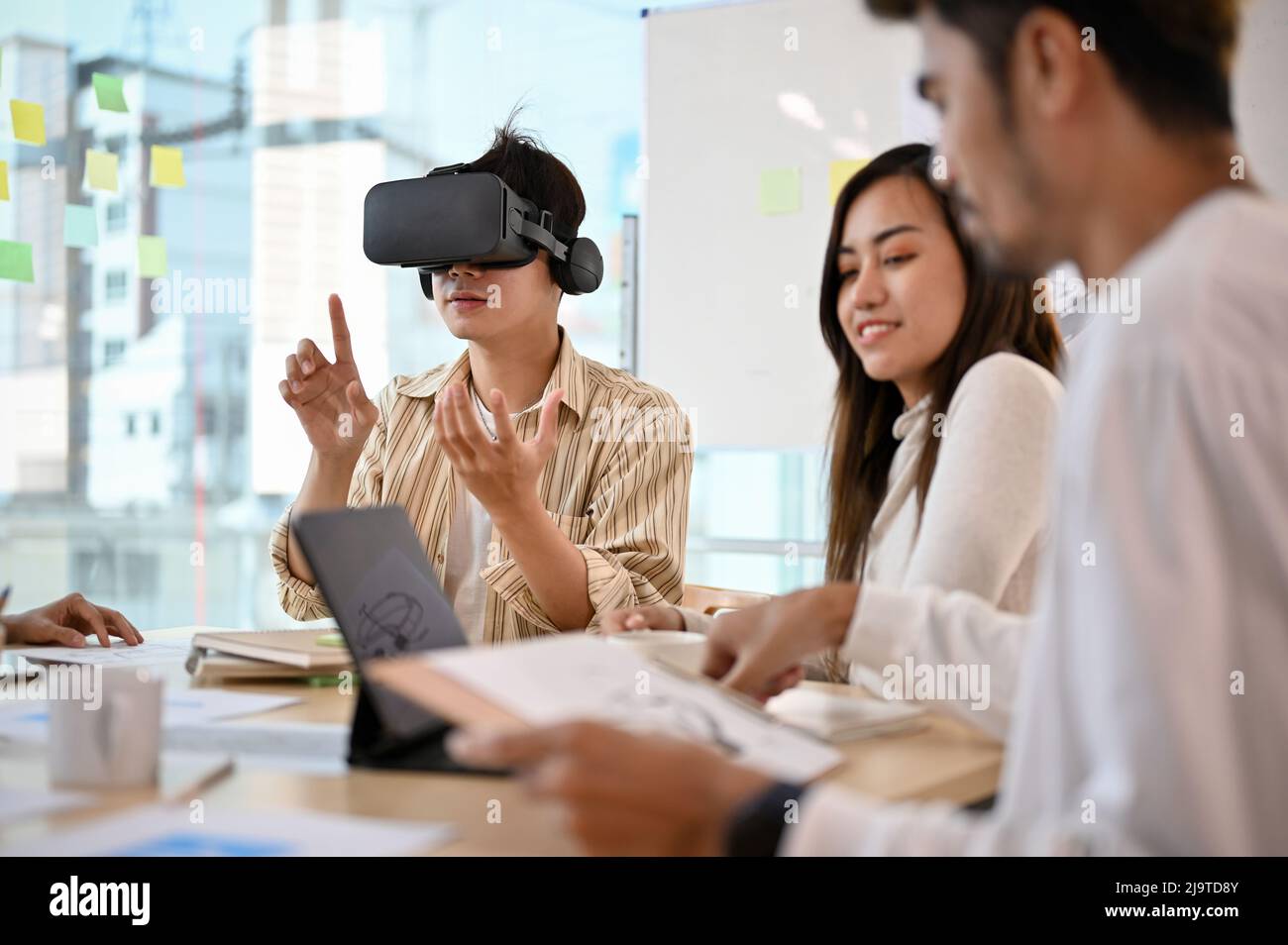 Young Asian male tech developer excited with his VR project, testing a ...