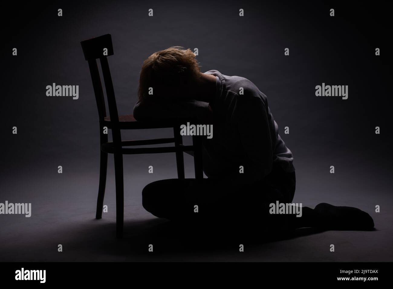 Man crying sitting on chair hi-res stock photography and images - Alamy