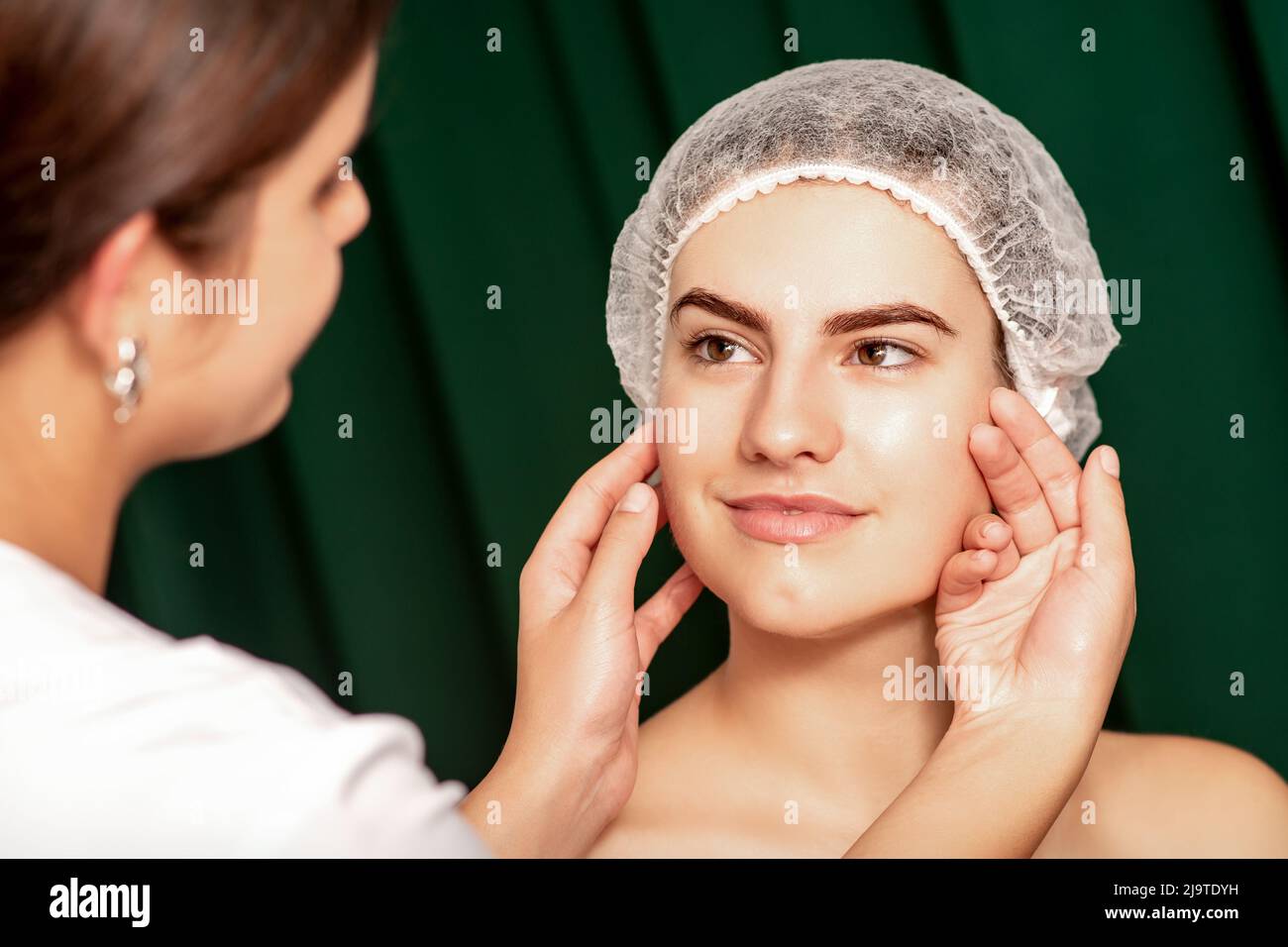 Plastic surgery and beauty concept. Professional cosmetician examining ...