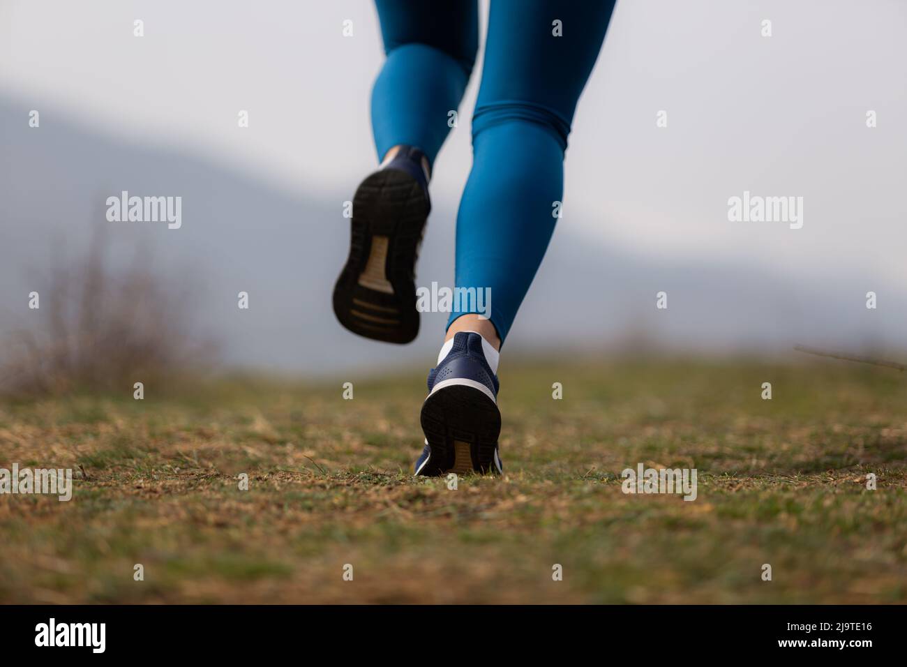 Amazing and active woman is running, close up at the shoes Stock Photo ...