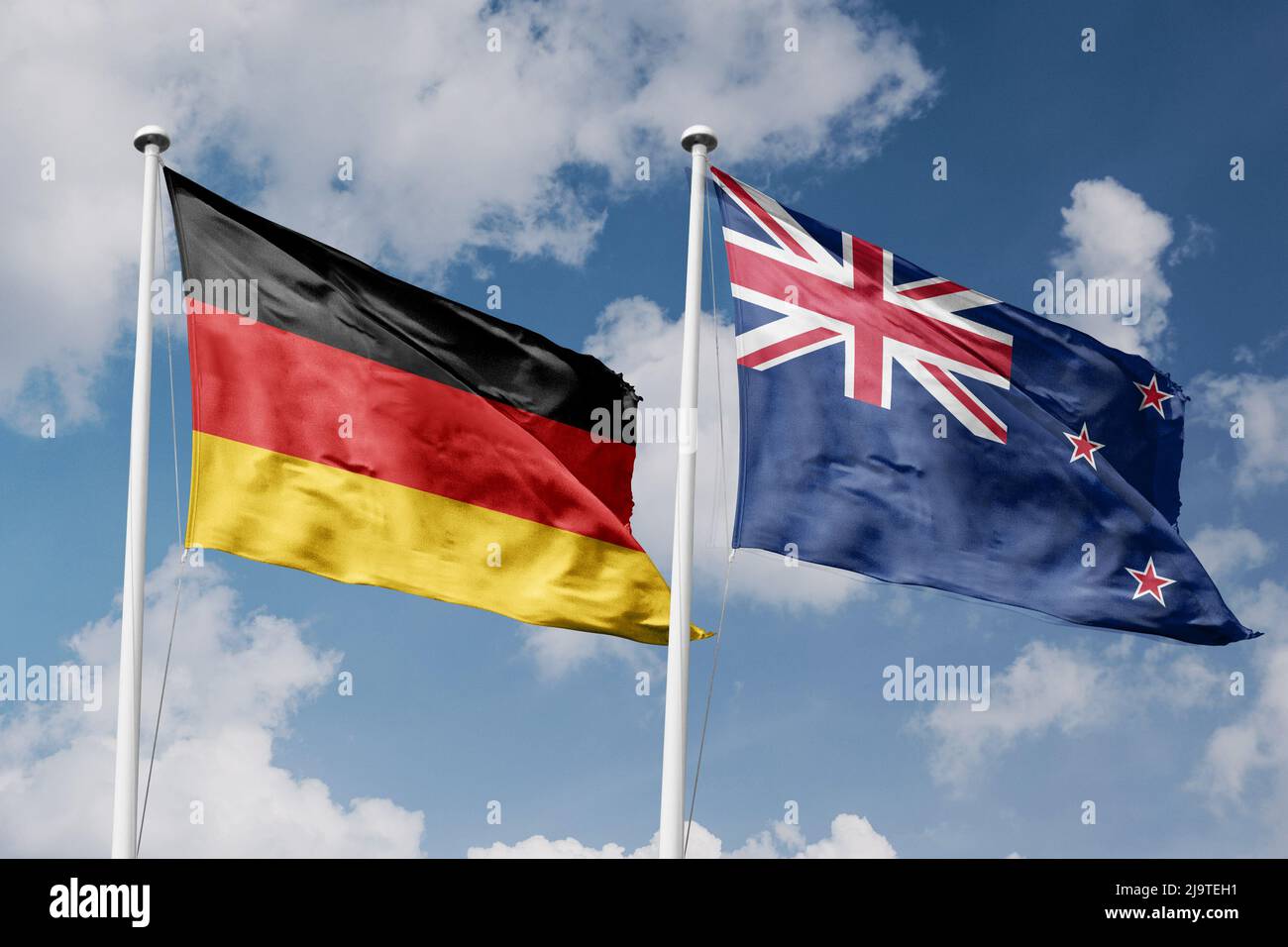 Germany and New Zealand two flags on flagpoles and blue cloudy sky background Stock Photo - Alamy