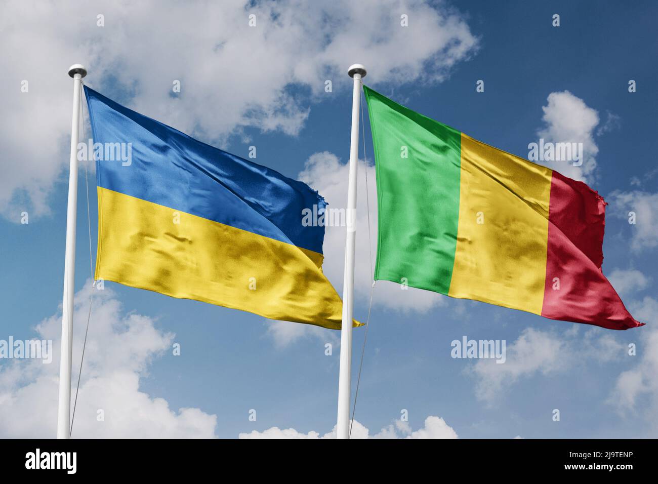 Ukraine and Mali two flags on flagpoles and blue cloudy sky background ...