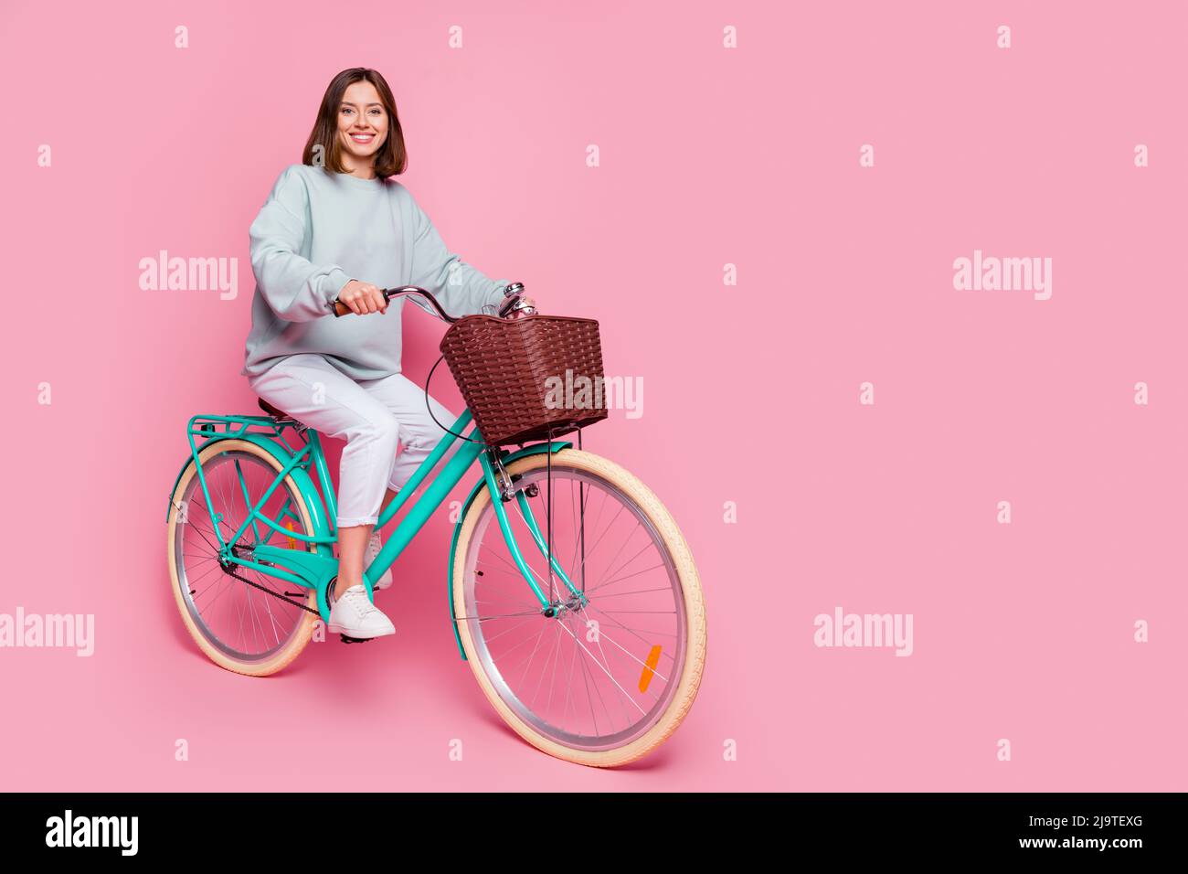 Full length profile side photo of young pretty girl ride bike weekend ...