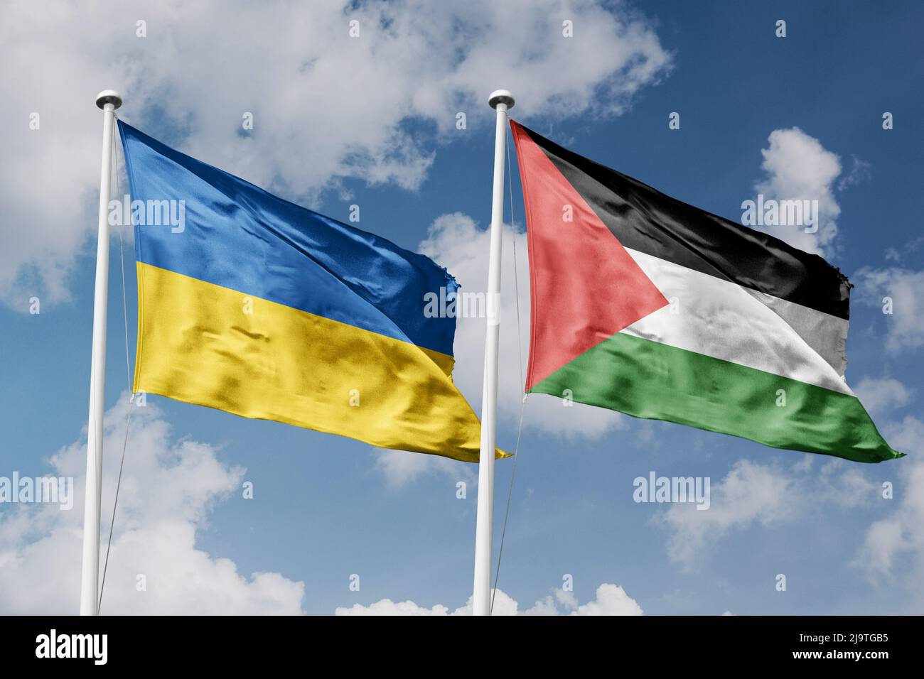 Ukraine and Palestine two flags on flagpoles and blue cloudy sky ...